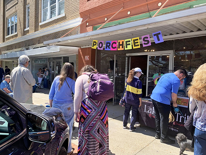 Porchfest brings neighbors together for free music and community connection. The colorful banner matches the vibrant spirit of this budget-friendly town.