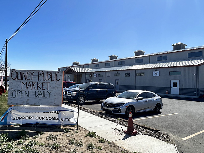 The Quincy Public Market's hand-painted sign says everything about this town—locally supported, charmingly imperfect, and absolutely essential to community life.