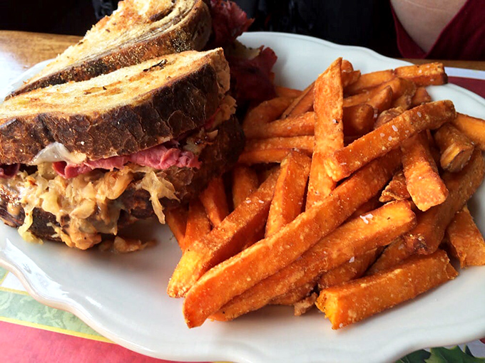 The Reuben sandwich—where sauerkraut, corned beef, and Swiss cheese hold their reunion tour, with sweet potato fries as the opening act.