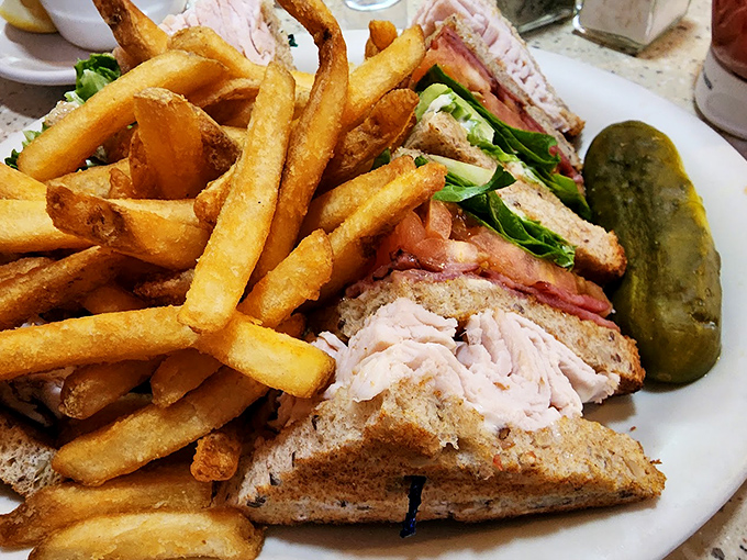 The club sandwich—architecture you can eat, with layers of turkey, bacon, and vegetables forming a skyscraper of satisfaction.