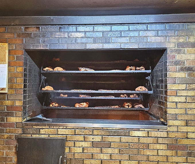 The holy grail of barbecue: a proper brick smoker with meat in various stages of transformation. This isn't cooking—it's a slow-motion miracle.