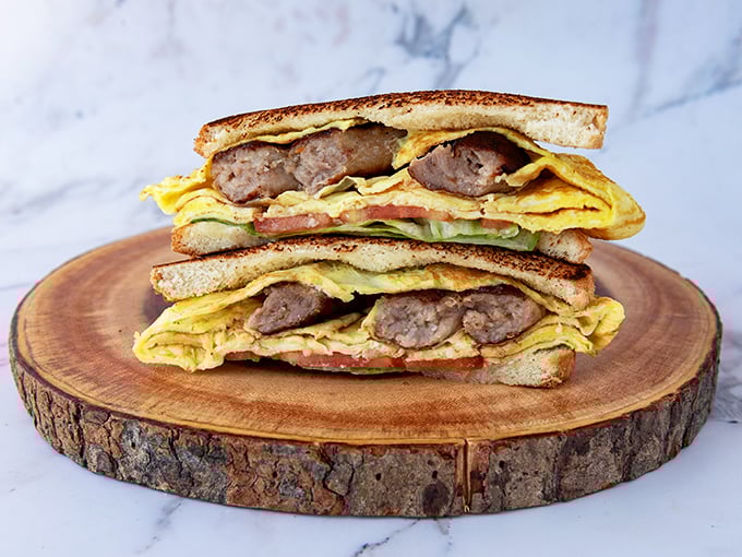 A breakfast sandwich that understands the importance of proper architecture—every ingredient in perfect balance. The morning commute's best friend.