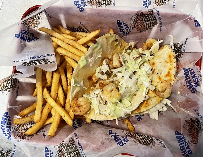 Not all heroes wear capes—some come wrapped in soft tortillas with crisp lettuce and perfectly seasoned shrimp. French fries standing guard.