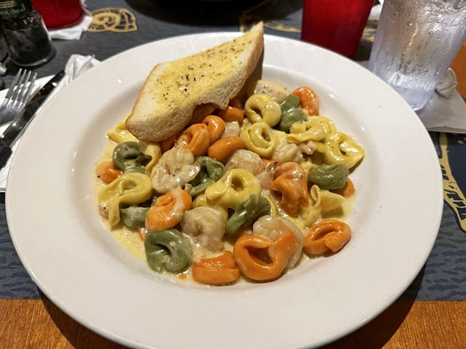 Colorful tortellini swimming in a creamy sauce with shrimp—like little pasta life preservers in a sea of deliciousness you'll want to dive into.