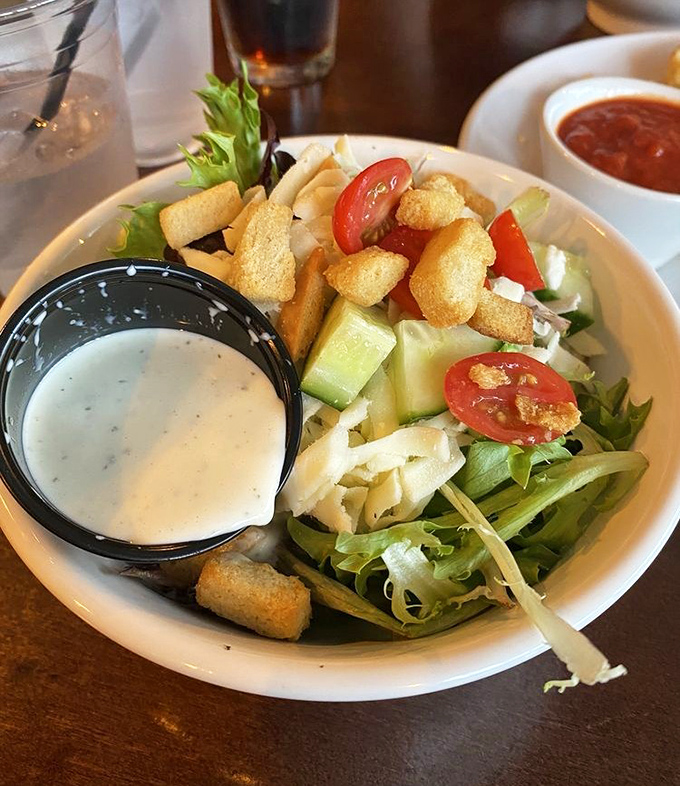 A side house salad that's actually worth ordering—fresh greens, crisp vegetables, and house-made dressing that puts bottled versions to shame.