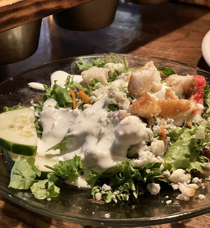 A salad that understands its supporting role—fresh greens, croutons, and blue cheese creating the perfect opening act before the beef headliner arrives.