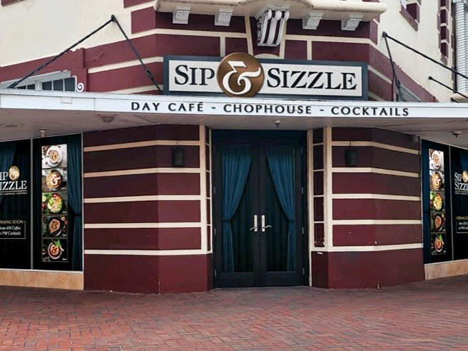 Sip & Sizzle's distinctive corner entrance beckons with the promise of cocktails and conversation—a grown-up reward after a day of Florida exploration.