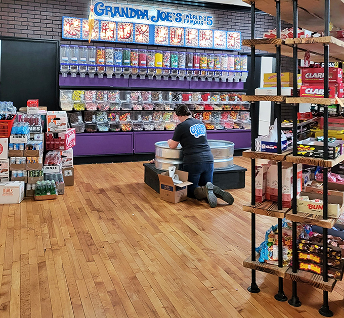 Restocking the candy wall—a job that requires the precision of a surgeon and the willpower of a saint.