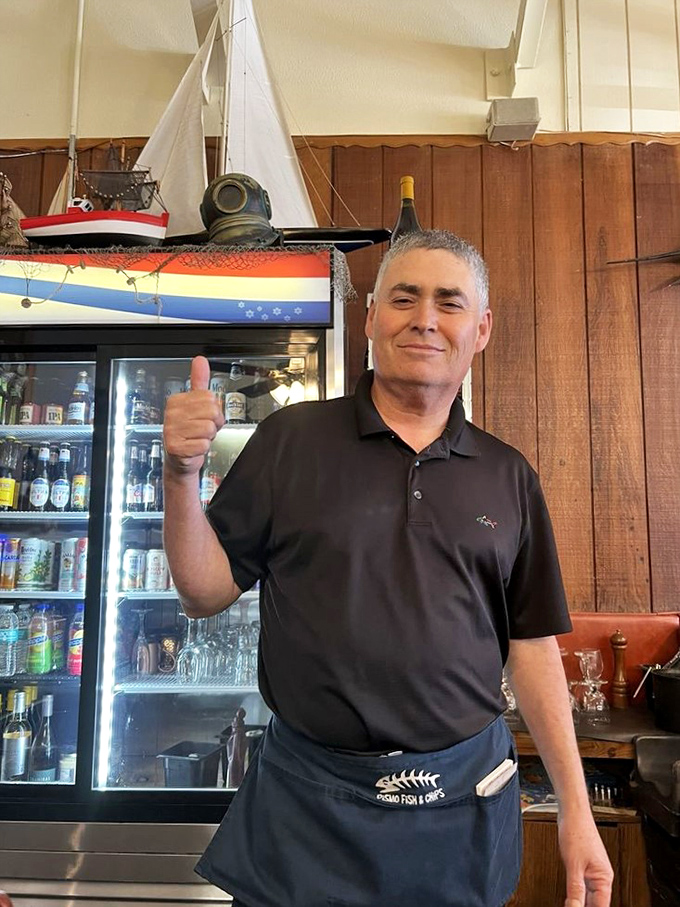 The staff brings decades of seafood expertise to every plate. That thumbs-up isn't just a pose—it's a promise.