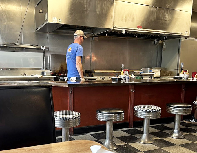 Where the magic happens—classic diner counter seating that puts you front-row for the culinary show. Those chrome stools have witnessed countless coffee refills.