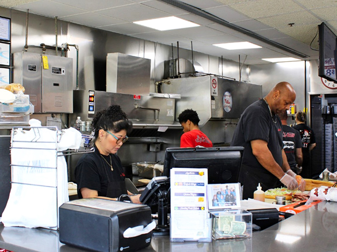 The sandwich artists at work—where efficiency meets passion and every slice of meat is placed with the precision of a surgeon.