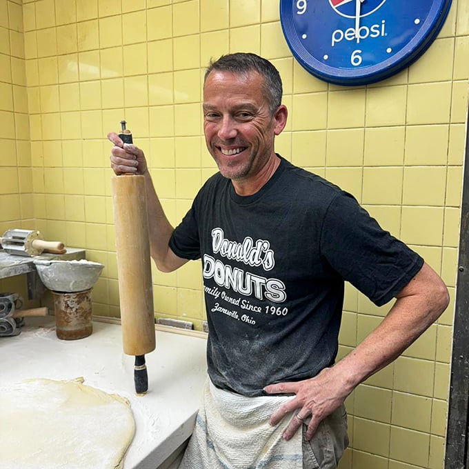 The maestro at work with his trusty rolling pin. Behind every great donut is a dedicated baker who understands that perfection can't be rushed – or mass-produced.