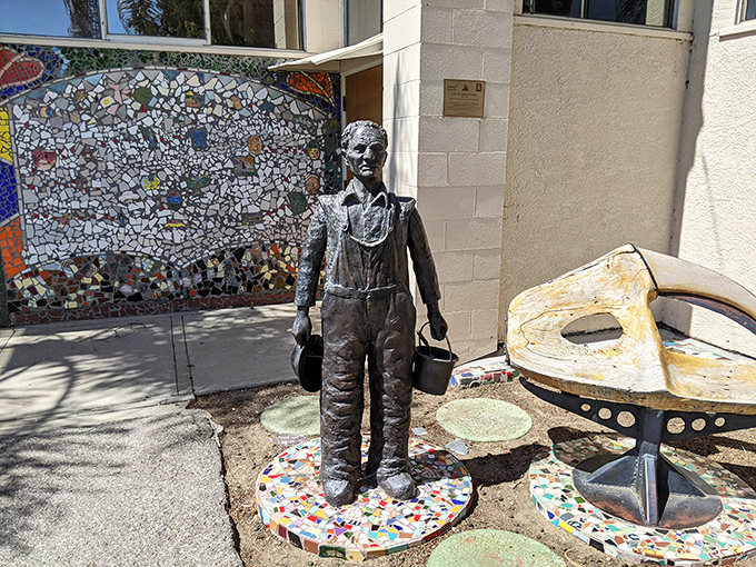 This bronze tribute captures the spirit of the towers' creator—buckets in hand, ready to transform discarded objects into enduring beauty.