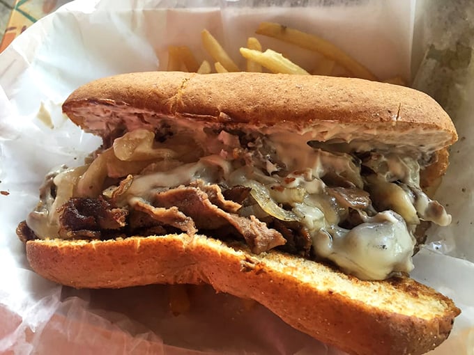 A sandwich so loaded with steak and melty cheese, it requires both hands, several napkins, and absolutely zero regrets.
