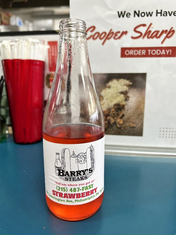 Strawberry soda that's unapologetically pink—because sometimes your cheesesteak deserves a sweet, fruity sidekick with retro charm.