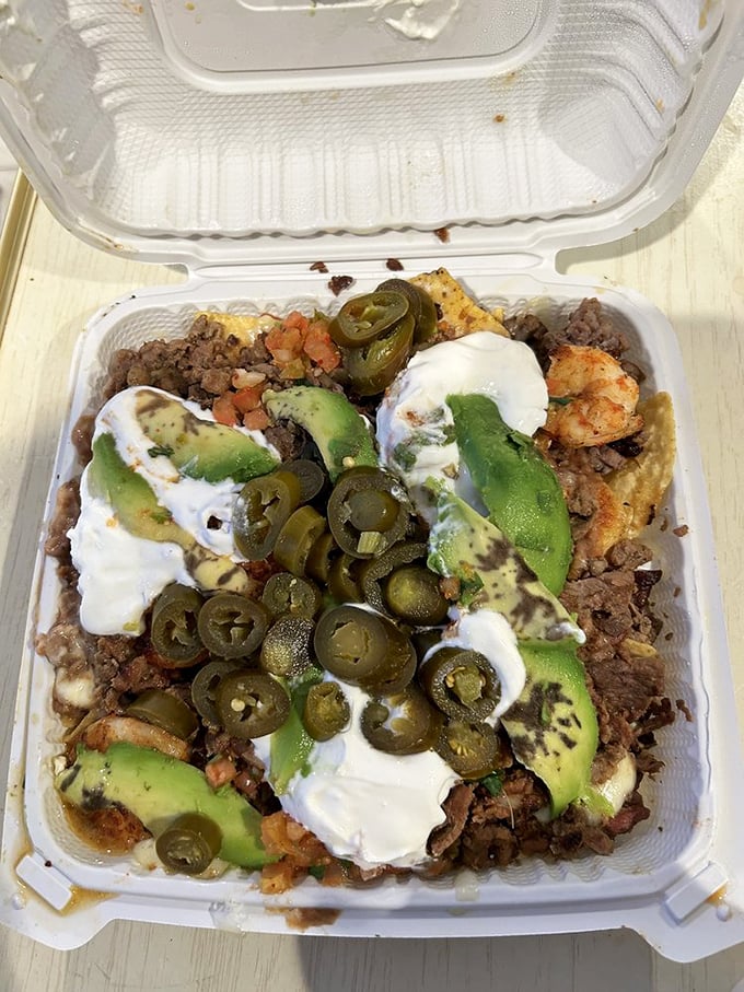 This isn't just nachos – it's a geological expedition through layers of beans, meat, jalapeños, and avocado that requires both strategy and commitment.