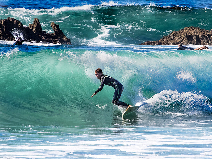 Surfers call this "the office" – where meetings involve reading waves instead of emails, and success is measured in perfect rides. 