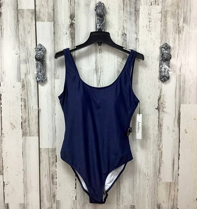 Navy simplicity meets summer confidence. This classic one-piece proves good swimwear design never goes out of style, just changes owners.