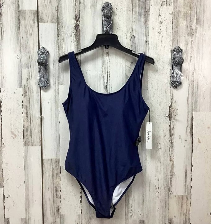 Navy simplicity meets summer confidence. This classic one-piece proves good swimwear design never goes out of style, just changes owners.