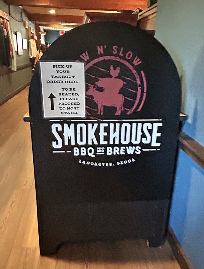 The smoker-shaped sign directing hungry patrons is both practical and thematic – barbecue wayfinding at its finest.