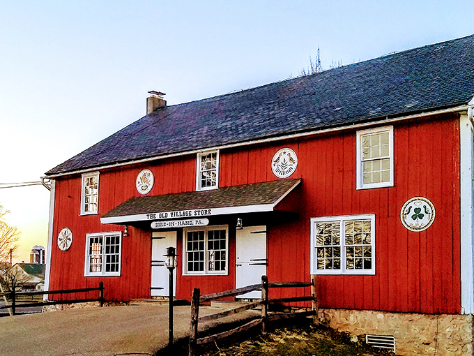 The Old Village Store stands as a crimson reminder that shopping was once a community affair rather than an algorithm-driven experience.