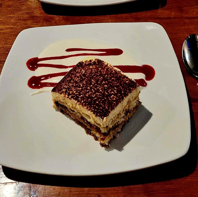 This tiramisu isn't just dessert—it's architecture. Precise layers of coffee-soaked ladyfingers and mascarpone create the Manhattan skyline of sweet endings.