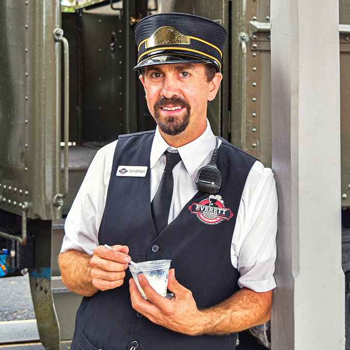 With a knowing smile and vintage uniform, this conductor isn't just checking tickets—he's your personal guide to railroad history.