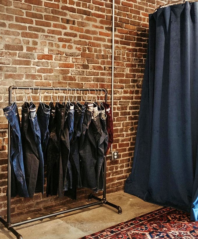 Denim heaven against rustic brick—this minimalist display proves sometimes less really is more in the world of sustainable fashion.