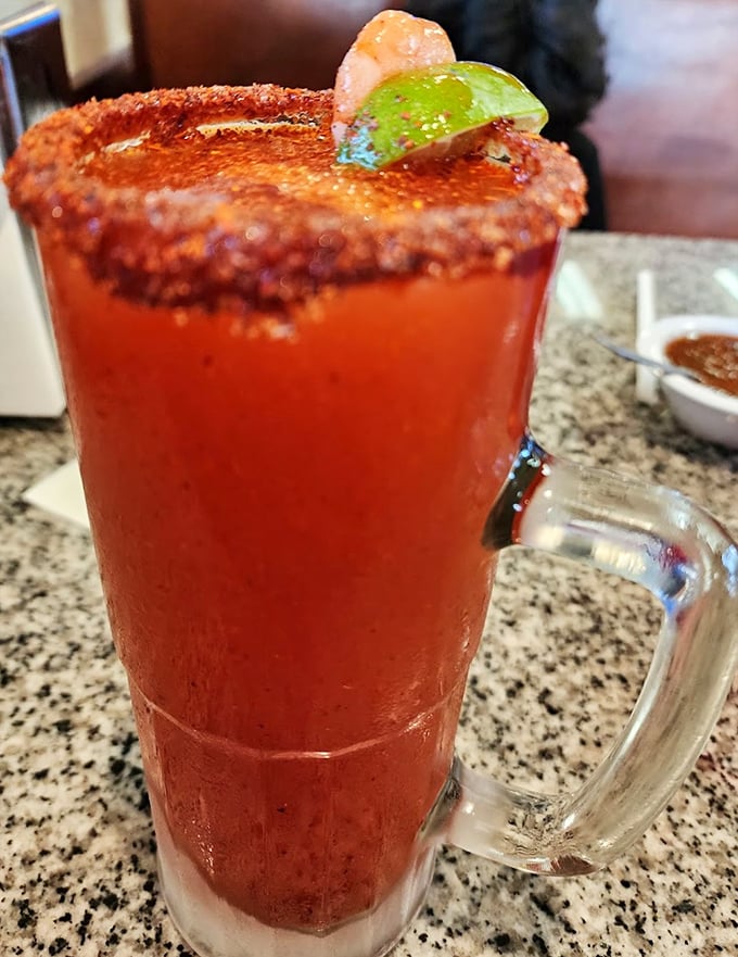 That rim isn't just spiced—it's weaponized with flavor. The michelada's vibrant red promises a kick that delivers on every sip.