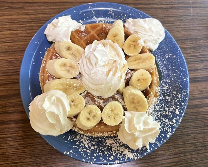This waffle doesn't just have bananas and whipped cream—it's wearing them like a crown jewel at a breakfast beauty pageant.