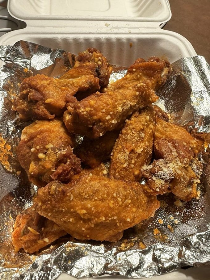 Golden-fried perfection in a takeout container. These wings aren't just food—they're a commitment to flavor that demands your full attention.