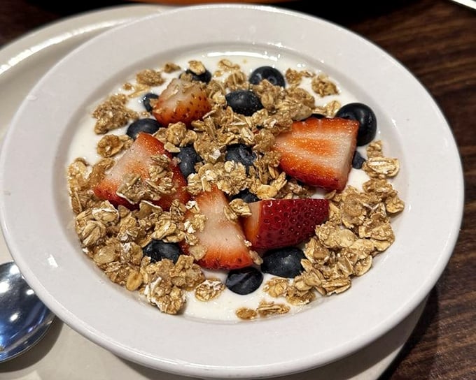 A bowl of yogurt, berries, and granola that somehow makes virtue feel indulgent—the breakfast equivalent of having your cake and eating it too.