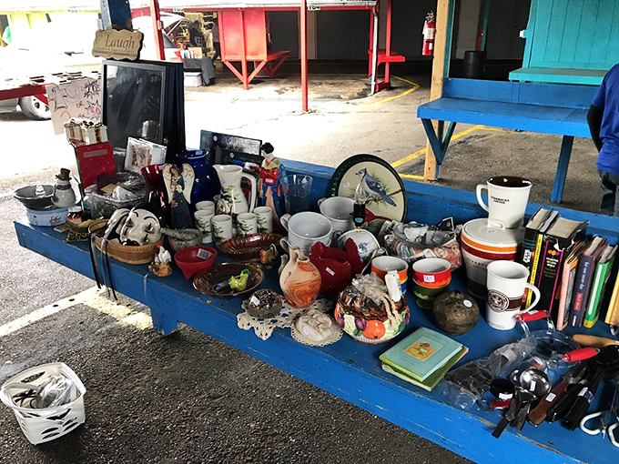 This blue table of miscellaneous treasures is like an analog version of your Facebook Marketplace feed—chaotic, mysterious, and utterly irresistible.