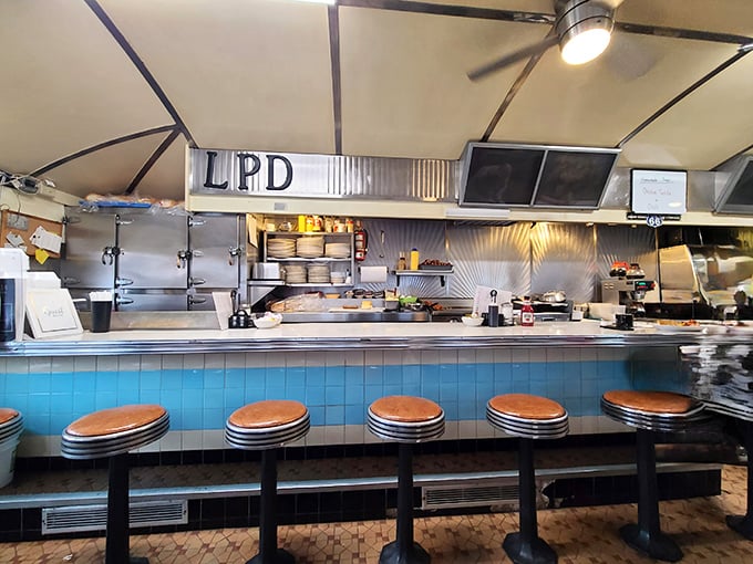 The open kitchen setup isn't just practical—it's dinner theater where short-order cooking becomes performance art with the sizzle as soundtrack.
