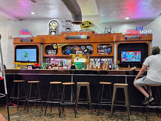 The bar area glows with neon beer signs and Pittsburgh sports memorabilia—a shrine where sandwich pilgrims can wash down their conquests with cold brews.