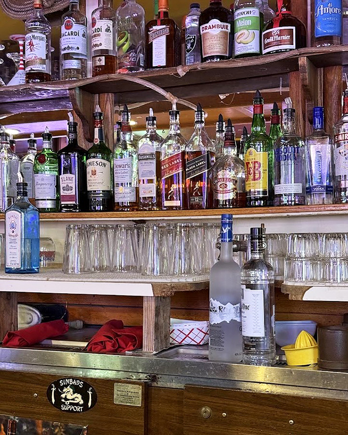 A bar shelf that says, "We're not here to impress you with obscure spirits—we're here to pour you something that works."