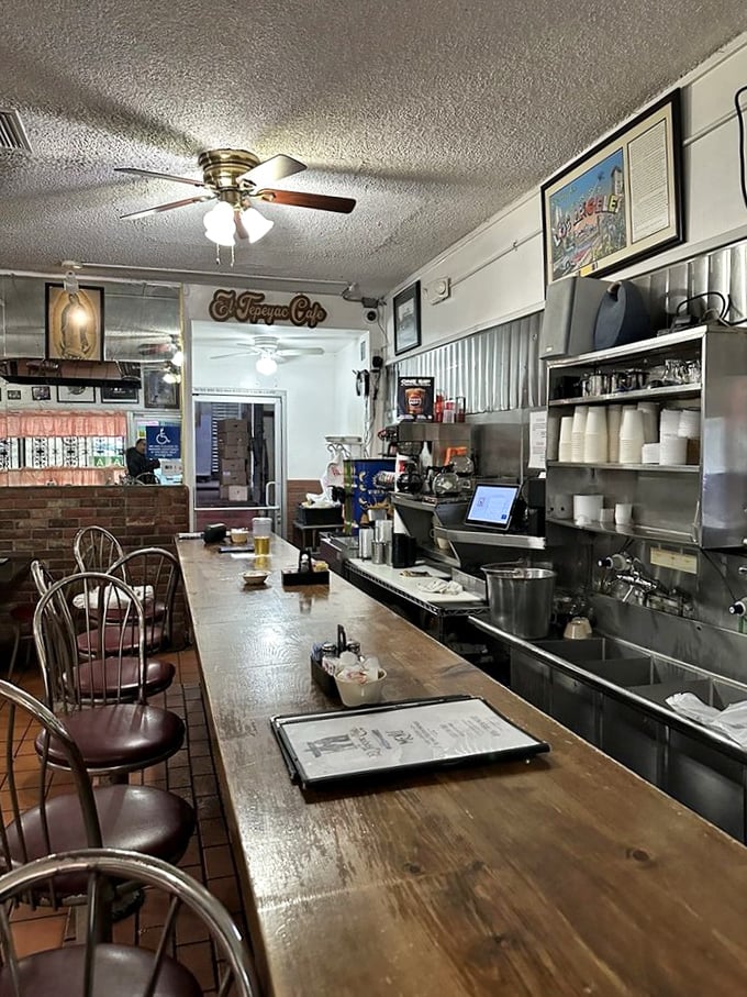 The counter where dreams begin and diets end. Notice the well-worn wood—polished by the elbows of decades of hungry patrons.