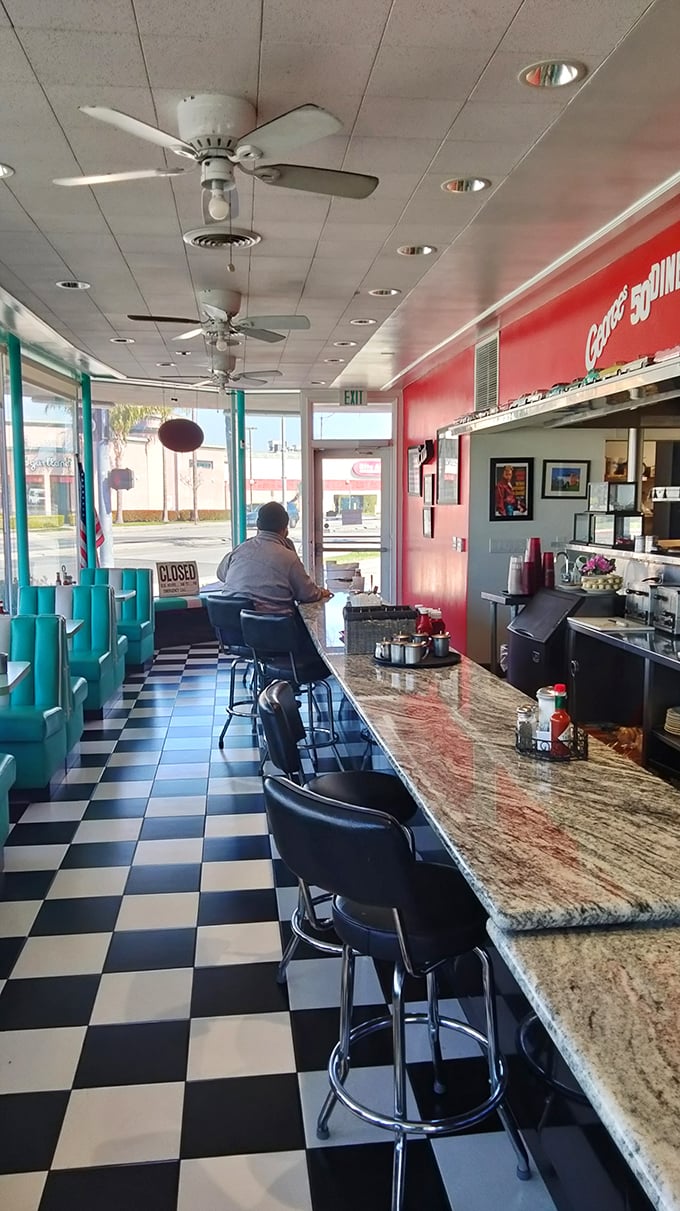 The counter—where solo diners find company, early birds catch their coffee, and the marble surface has heard more stories than a bartender.