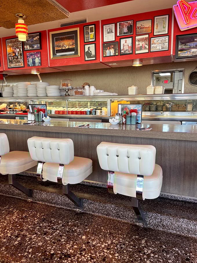 The counter isn't just seating—it's theater-in-the-round where you can watch short-order cooking elevated to an art form while vintage photos document decades of history above.