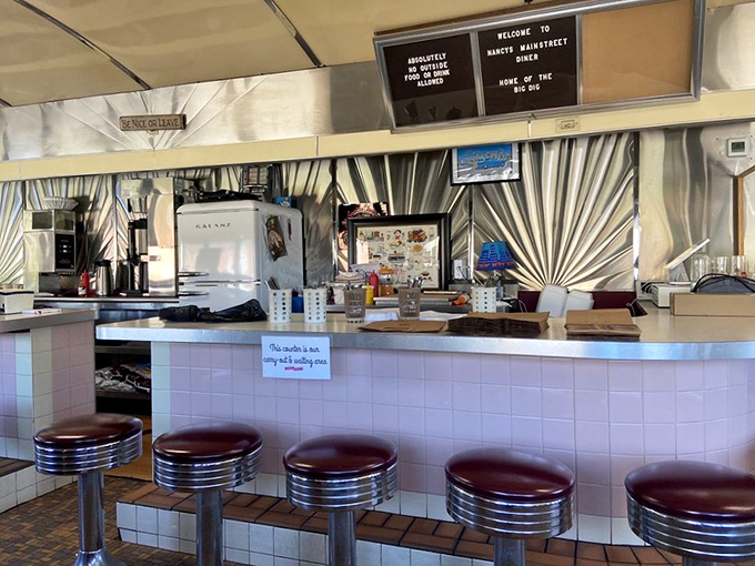 The counter where strangers become neighbors. That "Reserved" sign? It's for your future self—you'll be back tomorrow.