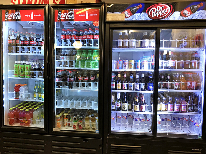 The drink coolers at Stanton's—where your beverage waits patiently to help you survive the glorious assault of flavors heading your way.