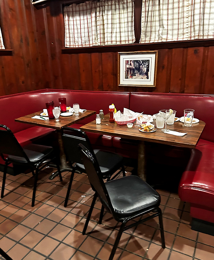 Red vinyl booths and wood paneling—the classic American tavern setting where comfort food tastes even better after a long day.