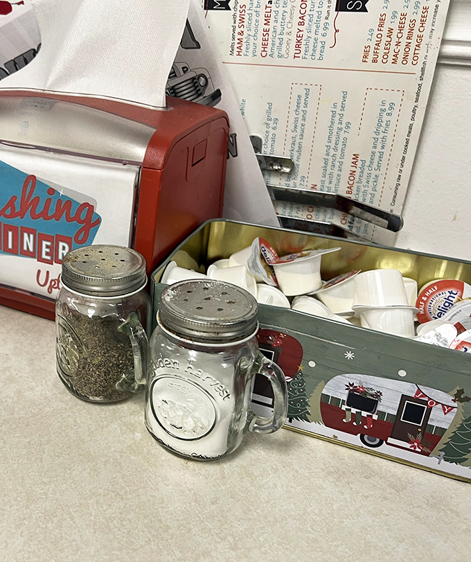 The salt and pepper in Mason jars aren't trying to be hipster—they were doing it before it was cool. That vintage napkin dispenser has seen things.