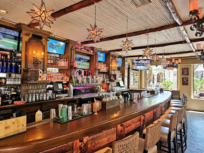 A bar that says "pull up a stool and tell me your troubles." Those star lanterns aren't just for ambiance—they're conversation starters after your second margarita.
