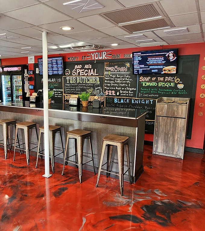 Industrial meets inviting with that striking red floor. The counter isn't just for ordering – it's front-row seating to culinary theater.