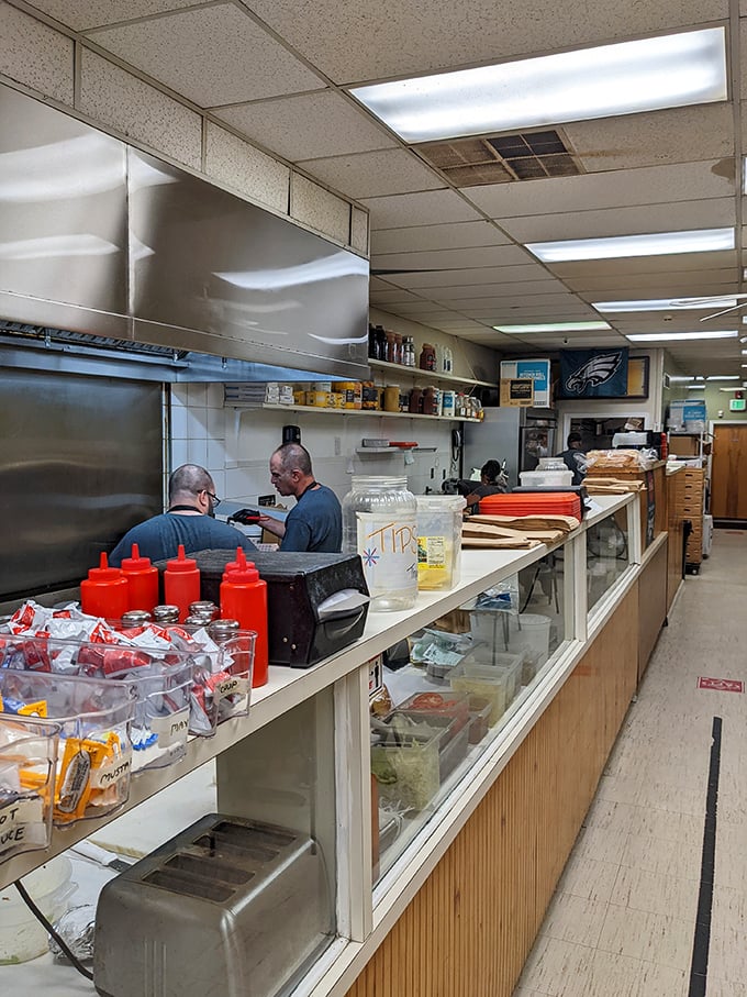 Where sandwich magic happens. Those red squeeze bottles aren't just condiment containers—they're flavor wands waiting to transform your meal.