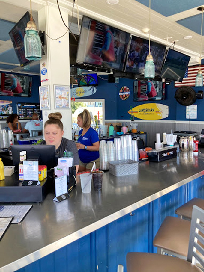Behind this vibrant blue bar, cocktail magic happens. The nautical touches aren't just decor—they're reminders that great seafood awaits just beyond those shakers.