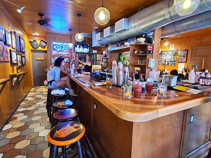 The bar at Frenchy's—where strangers become friends and friends become regulars. Wood-worn and wonderful, just as a beach bar should be.