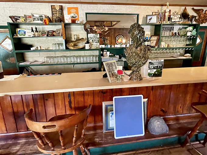 The bar area – where glasses gleam, wood paneling glows, and conversations flow as freely as the beverages.