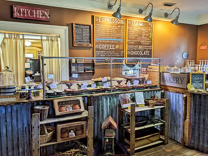 The bakery counter—where dreams come true and diets go to die. Each glass dome protects treasures more valuable than any crown jewel.